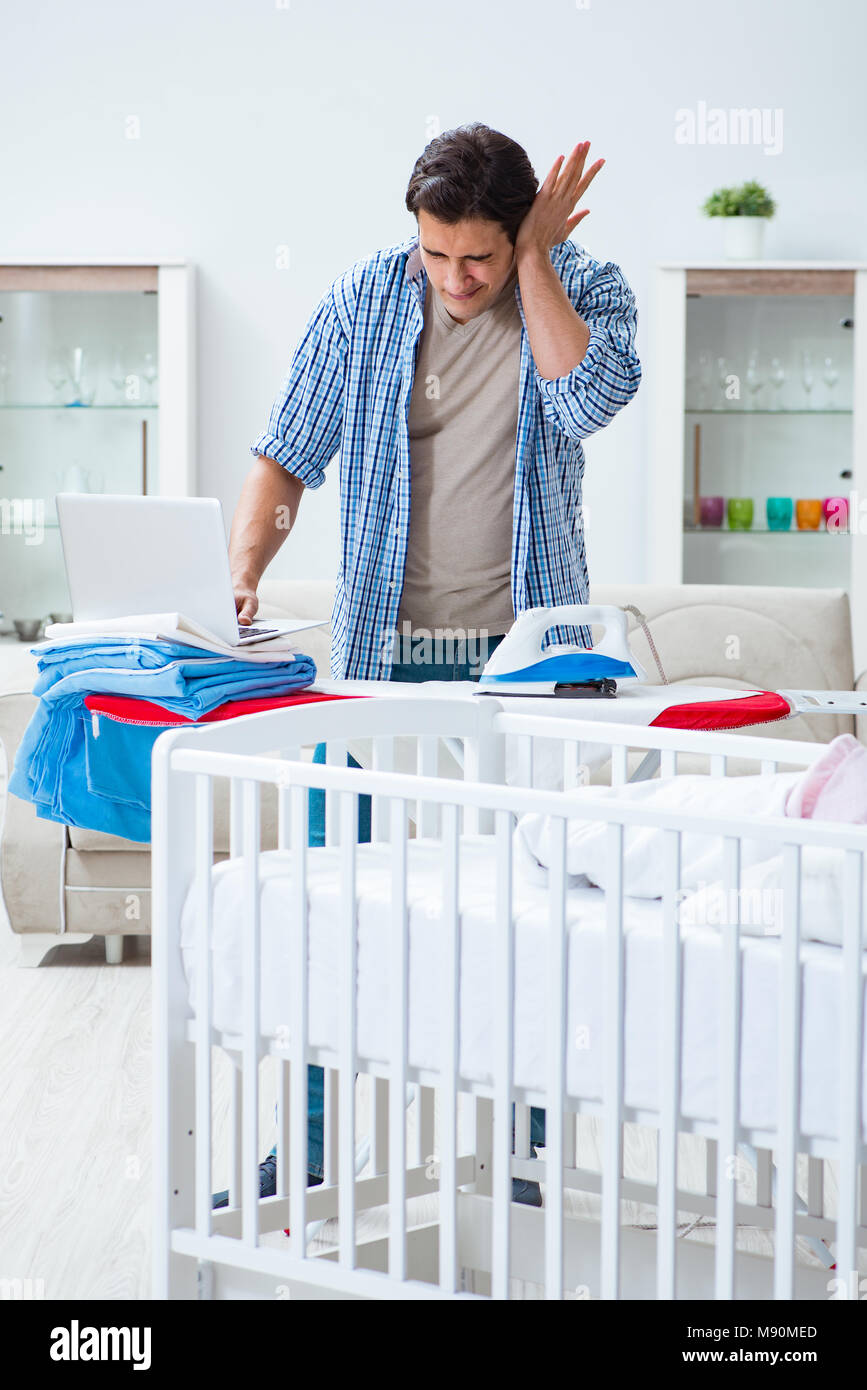 Young dad looking after newborn baby Stock Photo - Alamy