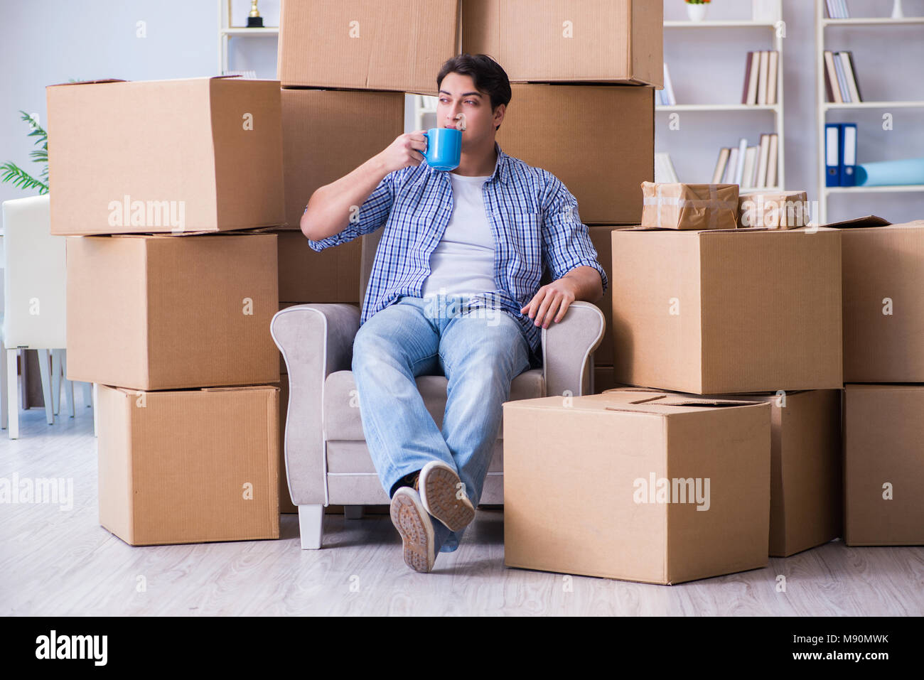 Young man moving in to new house with boxes Stock Photo - Alamy