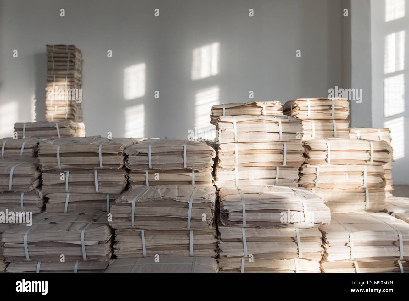 Stacked papers in room Stock Photo - Alamy