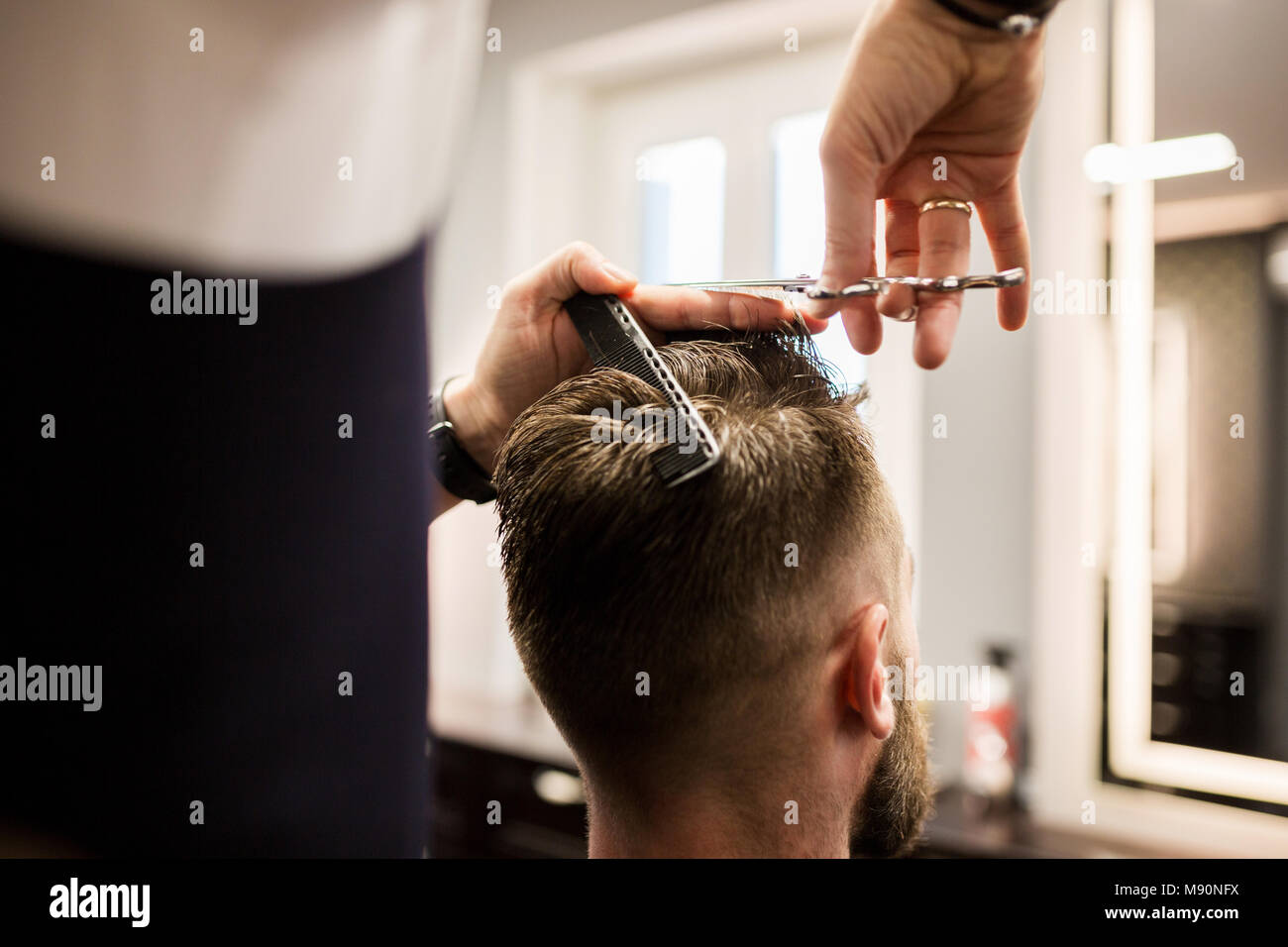 Modern barber holding scissors hi-res stock photography and images - Alamy