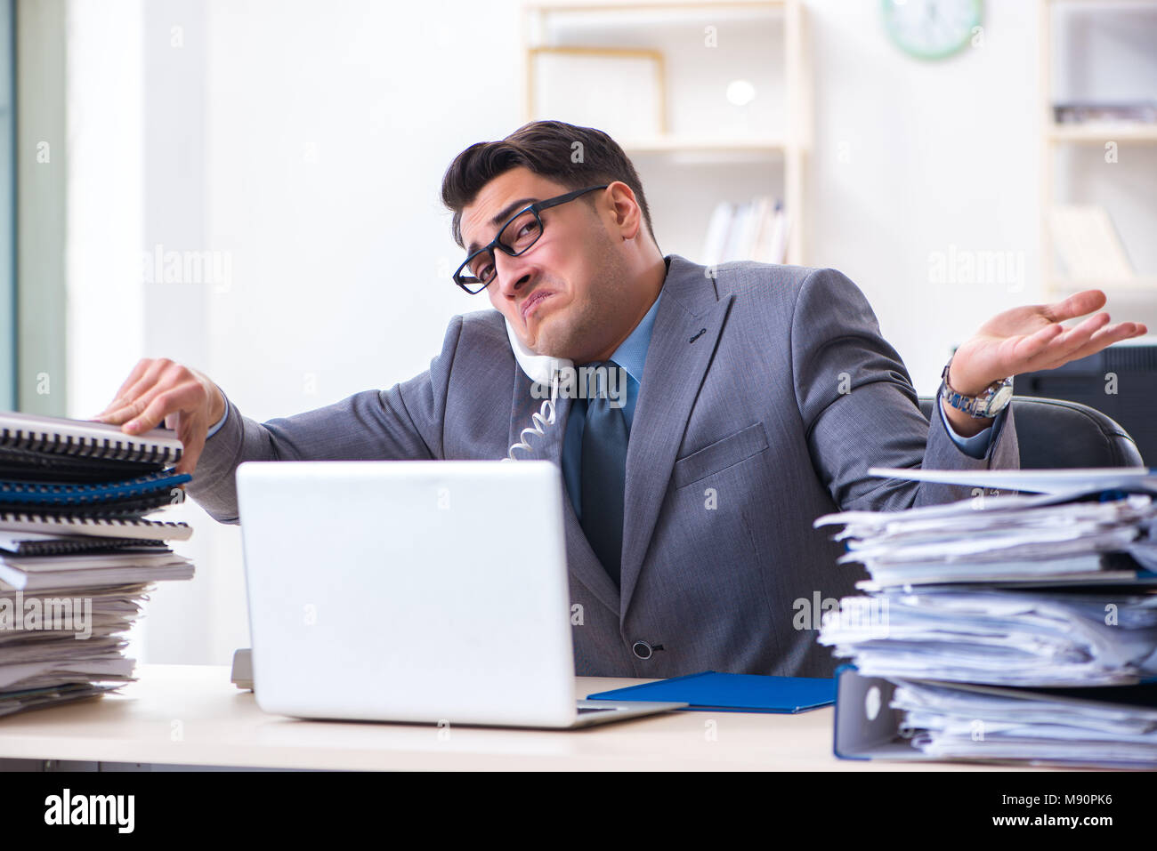Desperate sad employee tired at his desk in call center Stock Photo - Alamy