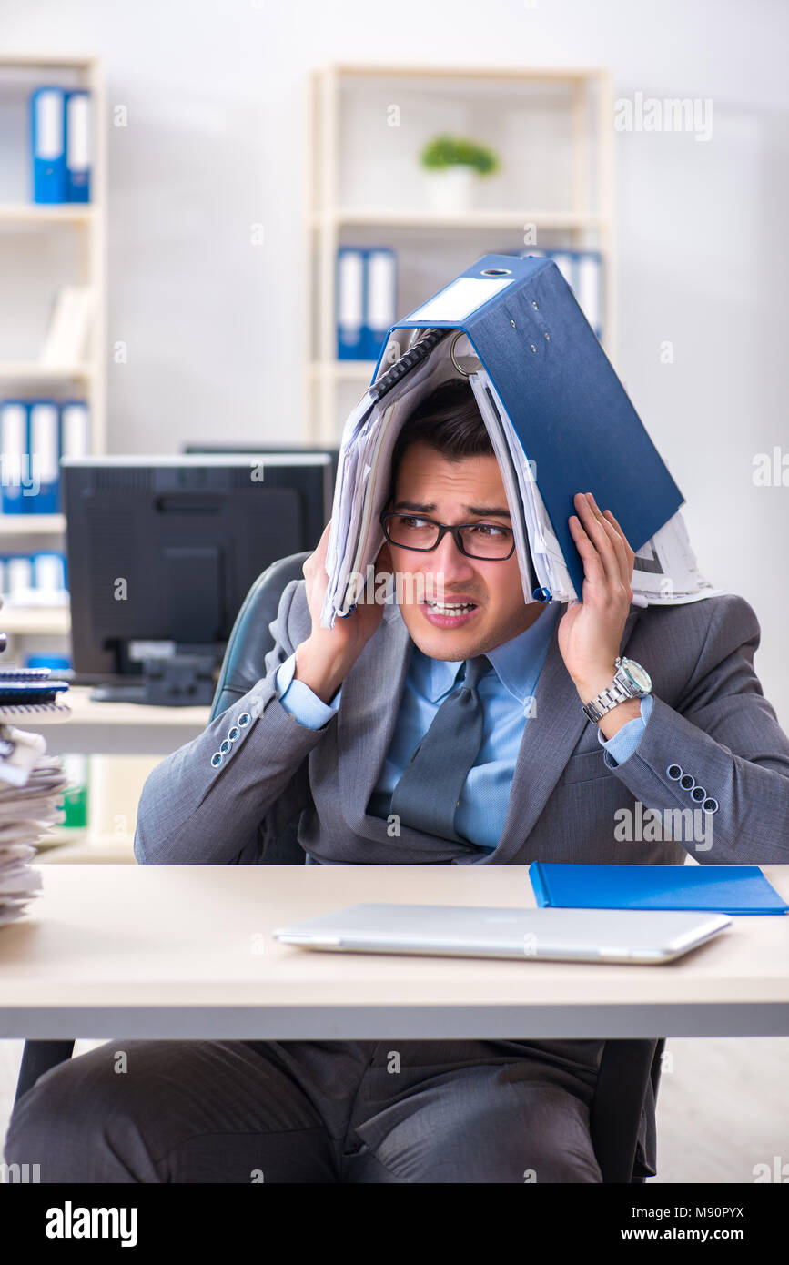 Overloaded with work employee under paperwork burden Stock Photo - Alamy
