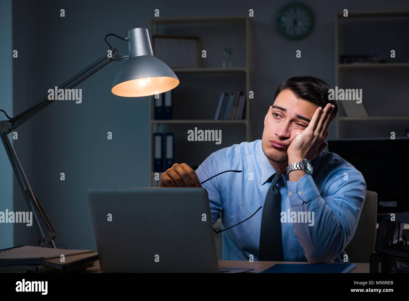 Employee working late at night at important report Stock Photo - Alamy