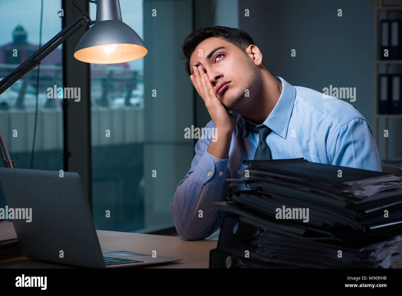 Employee working late at night at important report Stock Photo - Alamy