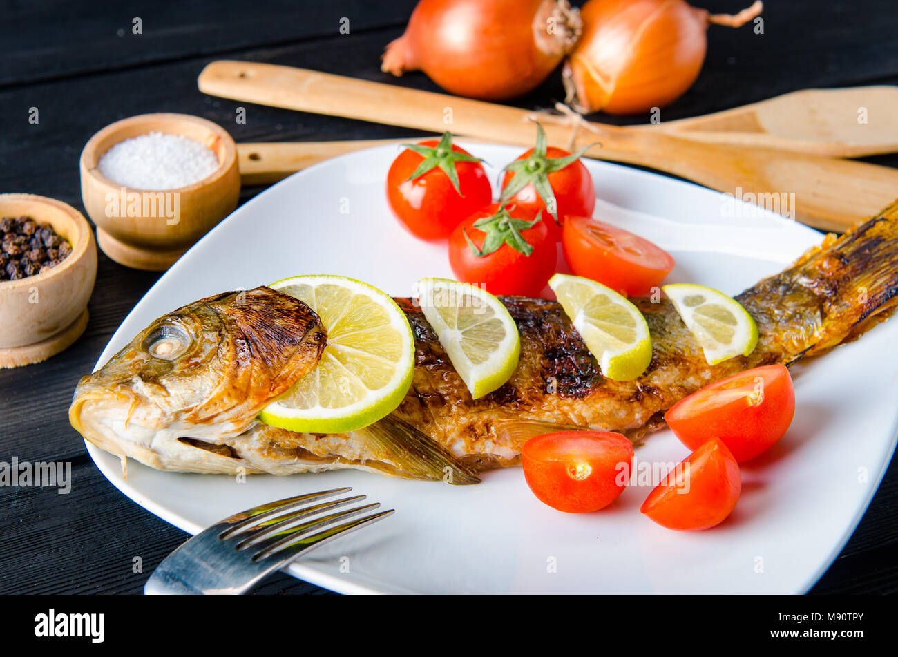 Fried fish served on the plate Stock Photo - Alamy