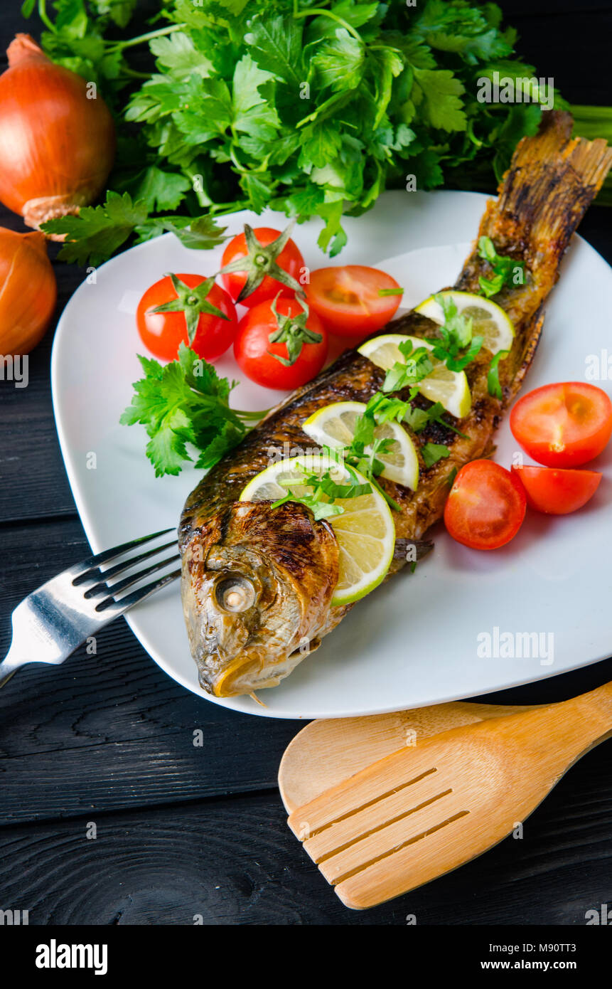 Fried fish served on the plate Stock Photo - Alamy