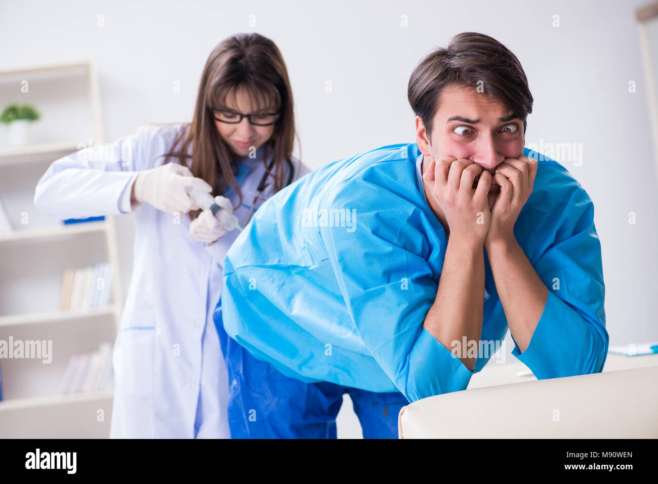 Funny man getting ready for buttocks syringe shot Stock Photo - Alamy