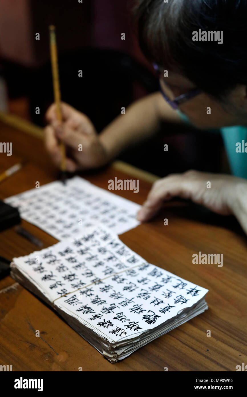 Taoist temple. Emperor Jade pagoda (Chua Phuoc Hai). Woman writing ...
