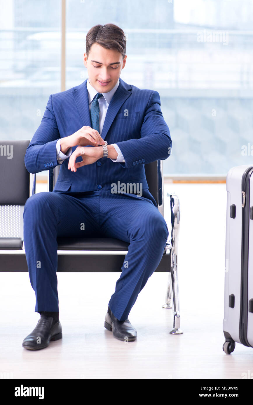 Businessman waiting at the airport for his plane in business class ...
