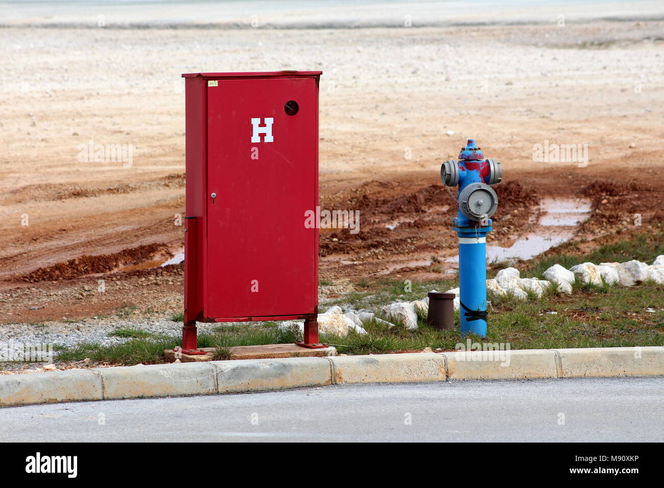 Metal blue fire hydrant with standard red fire department box next to ...