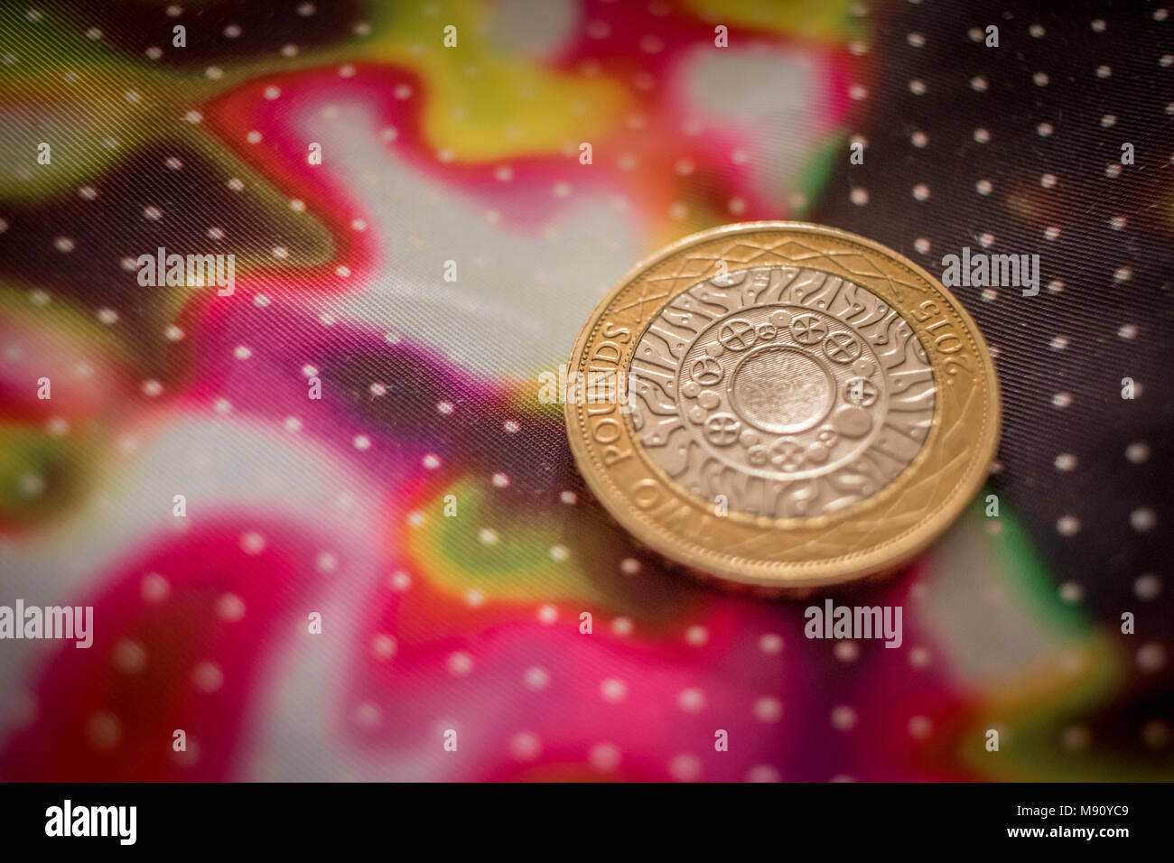 A two pound coin on a multicoloured background tails side up Stock ...