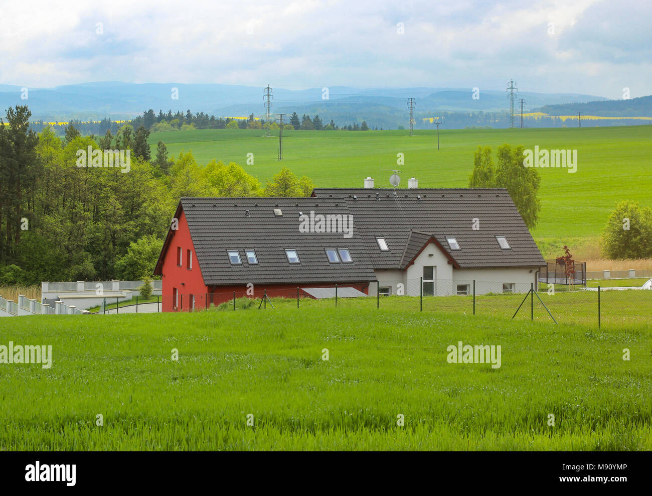 Country style house in the large green field Stock Photo - Alamy