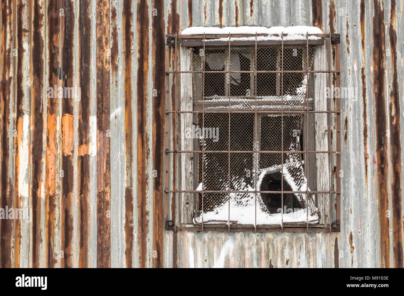 Rusty corregated metal wall with screened window Stock Photo - Alamy