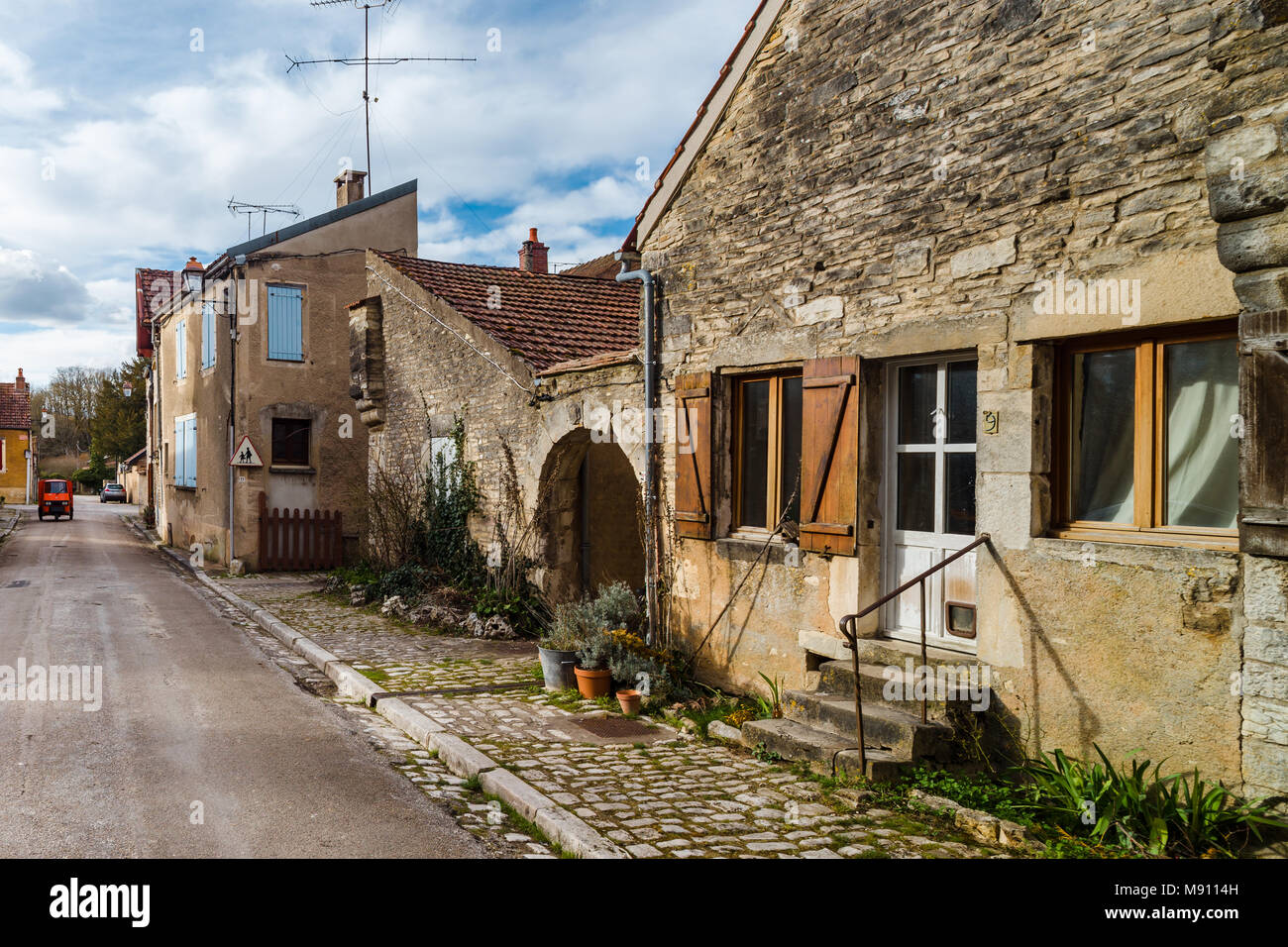 Old medieval houses on the cobbled street in ancient french village ...