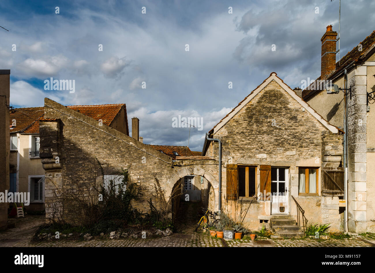 Old medieval houses on the cobbled street in ancient french village ...