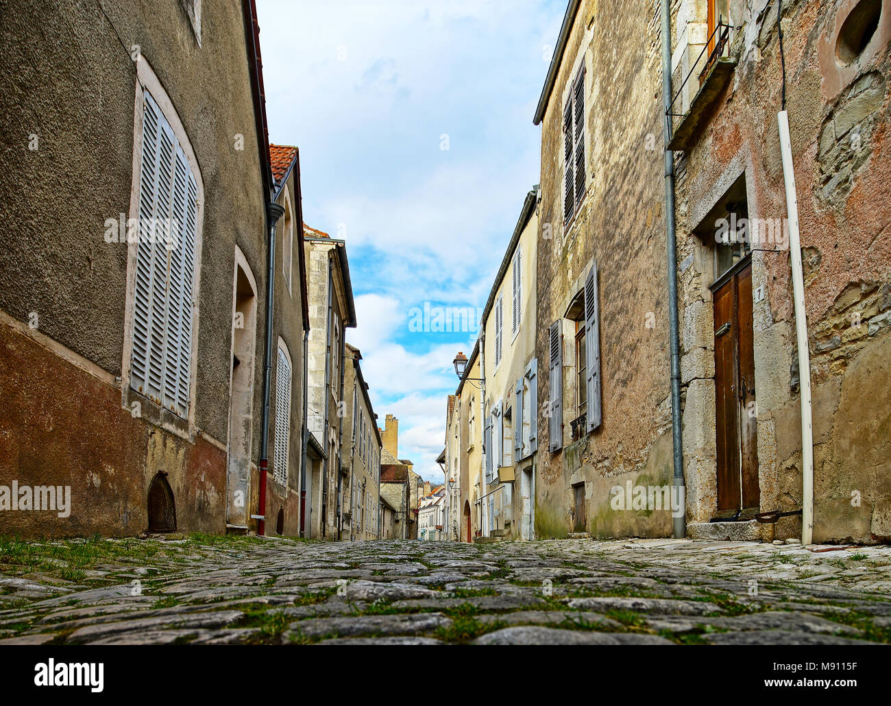 Old medieval houses on the cobbled street in ancient french village ...