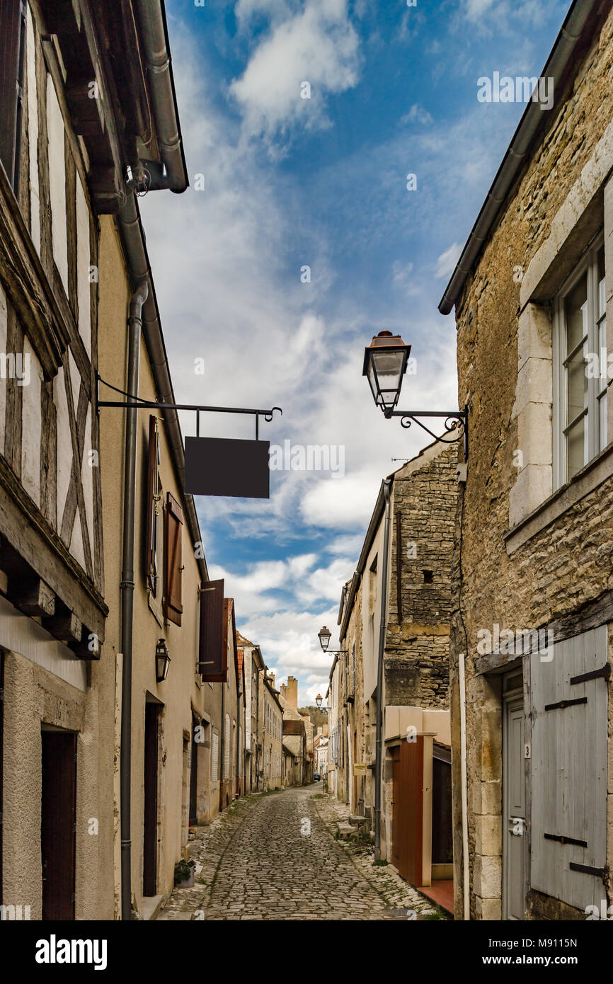 Old medieval houses on the cobbled street in ancient french village ...