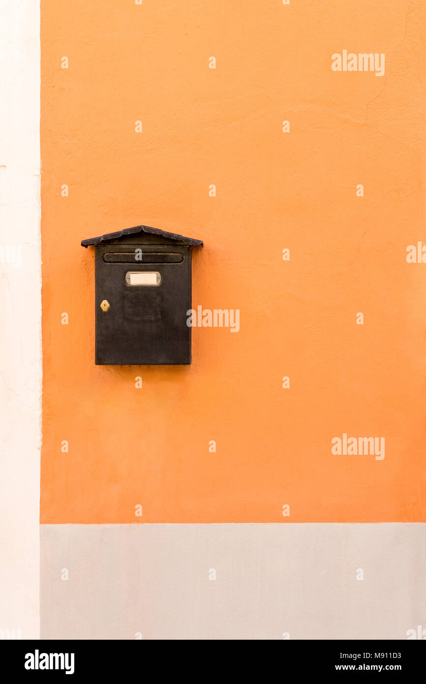 Old brown mail box on colorful wall Stock Photo - Alamy