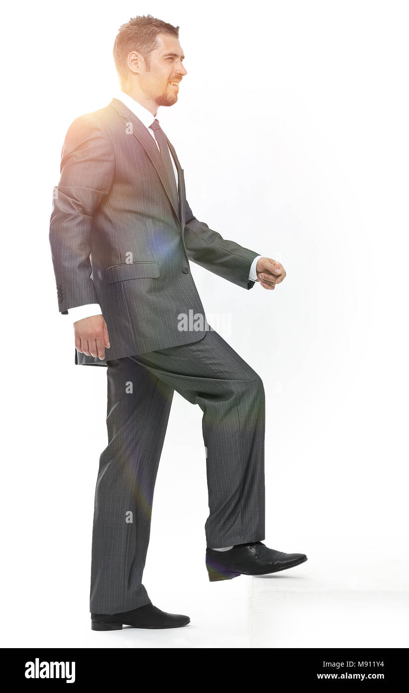 in full growth.side view.businessman stepping forward Stock Photo - Alamy