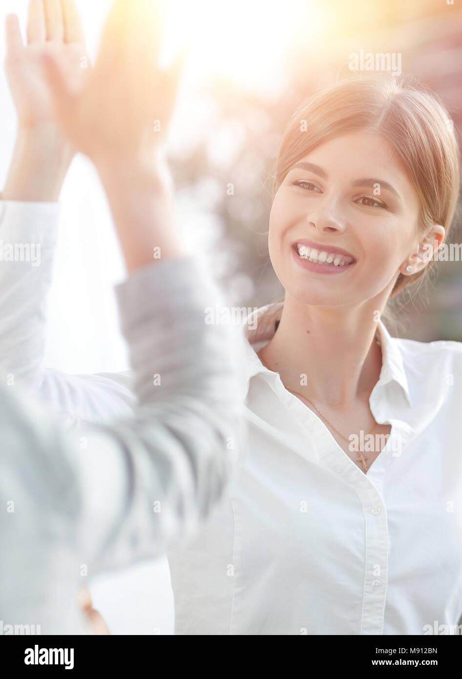 members of the business team giving each other a high five Stock Photo ...
