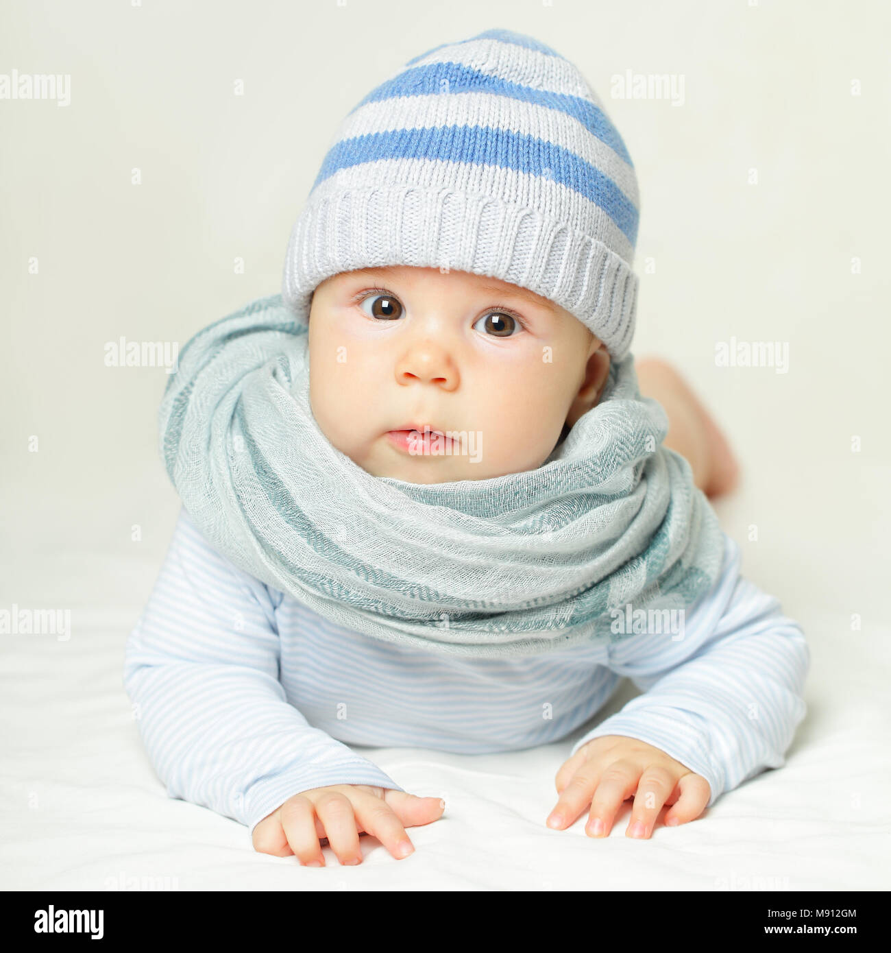 Cheerful baby in blue - small beautiful child, portrait Stock Photo - Alamy