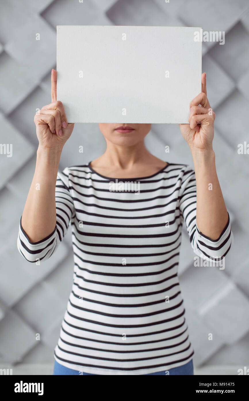 Sad depressed woman showing you the sheet of paper Stock Photo - Alamy