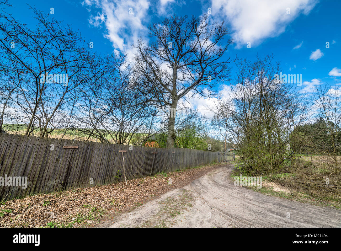 Rural road and wooden fence, spring landscape, countryside scene Stock ...