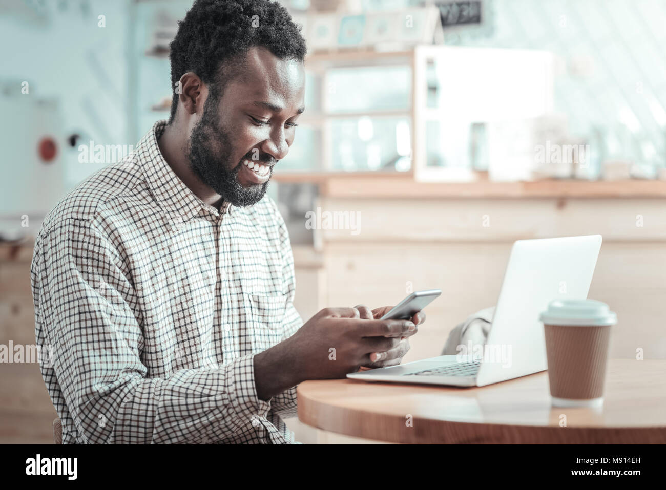 Happy cheerful man holding his smartphone Stock Photo - Alamy