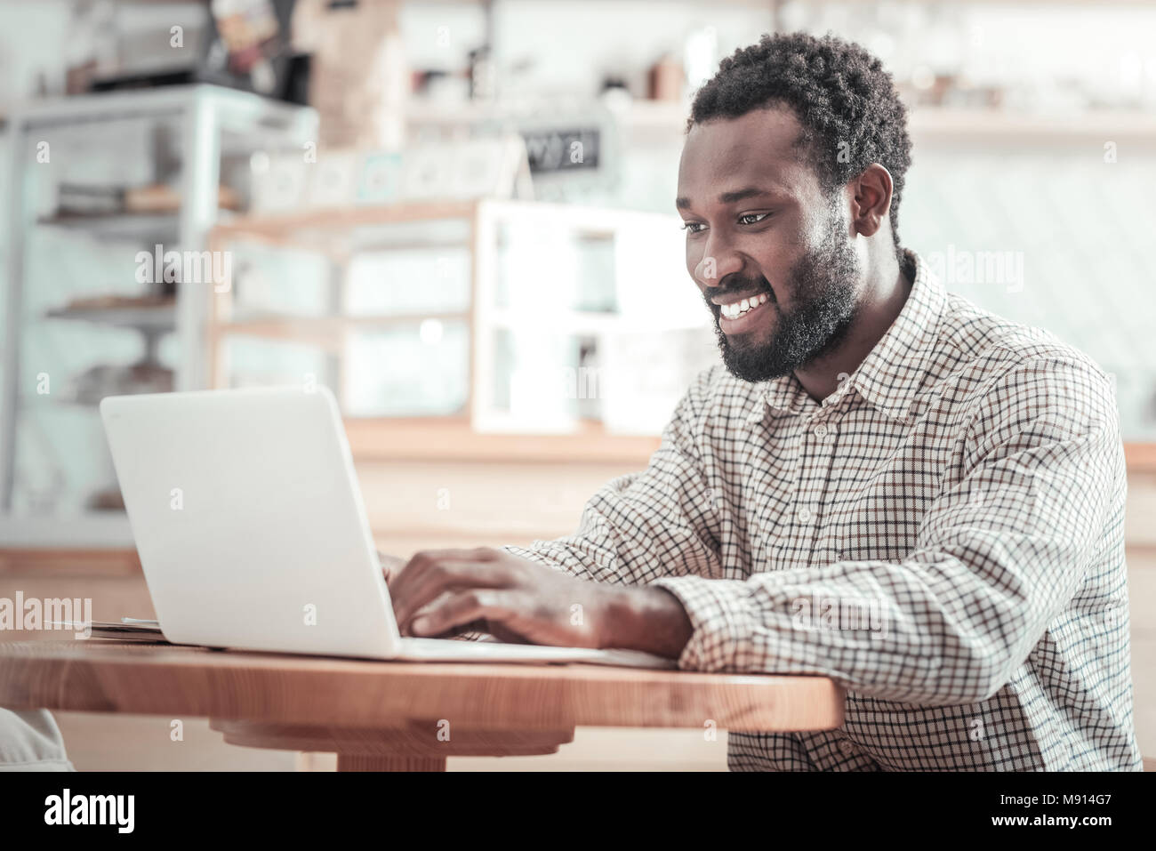 Happy nice man using the netbook Stock Photo - Alamy