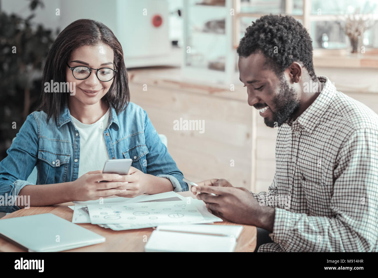 Positive happy people using their smartphones Stock Photo - Alamy