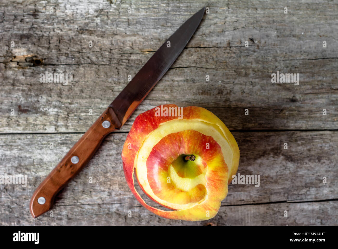 One apple with peeled peel on wooden table from above Stock Photo - Alamy