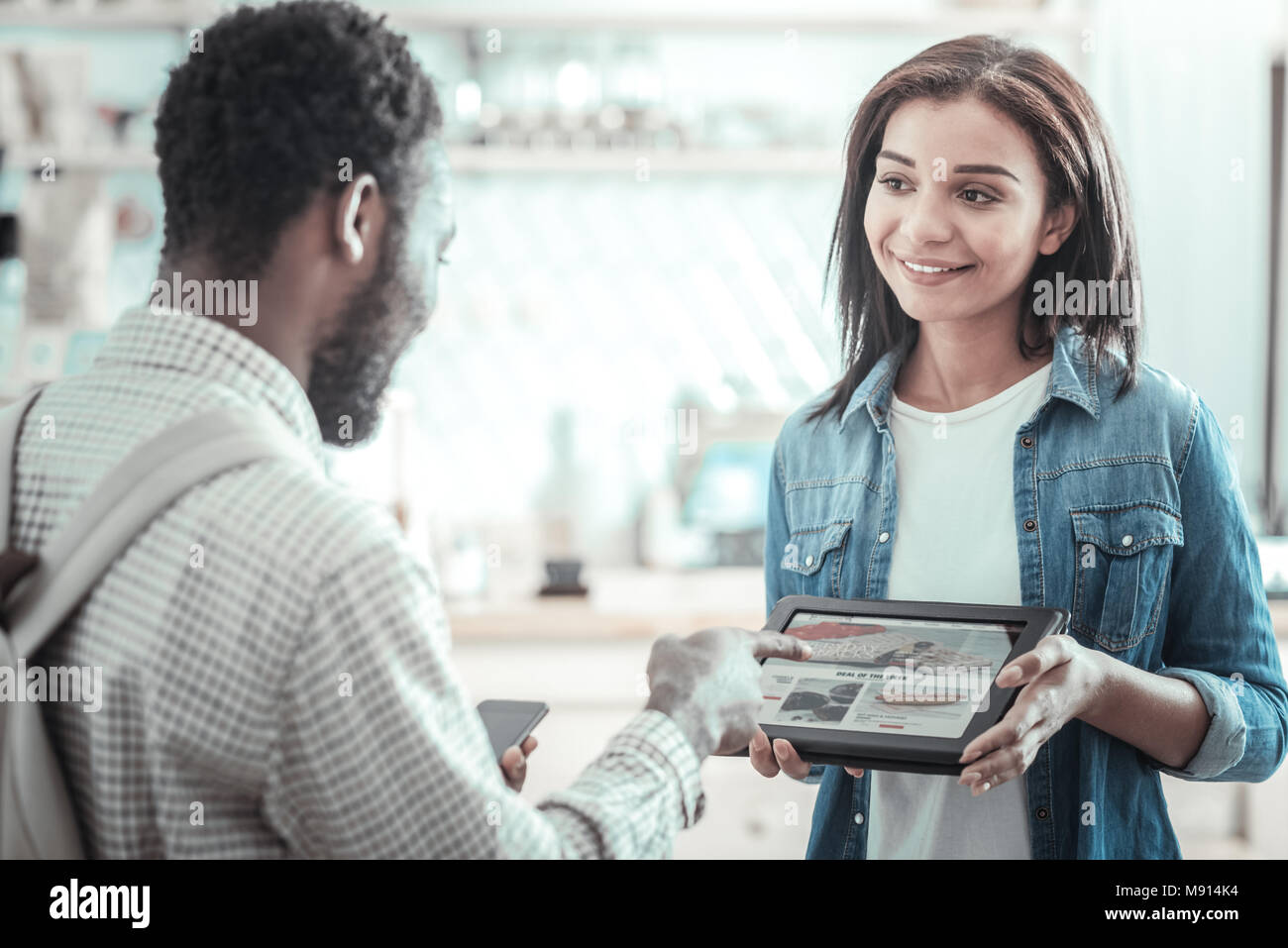 Happy nice man pointing at the tablet Stock Photo - Alamy
