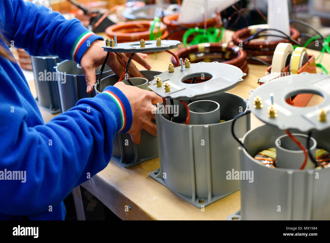 Worker working on new electrical transformers in workshop Stock Photo ...