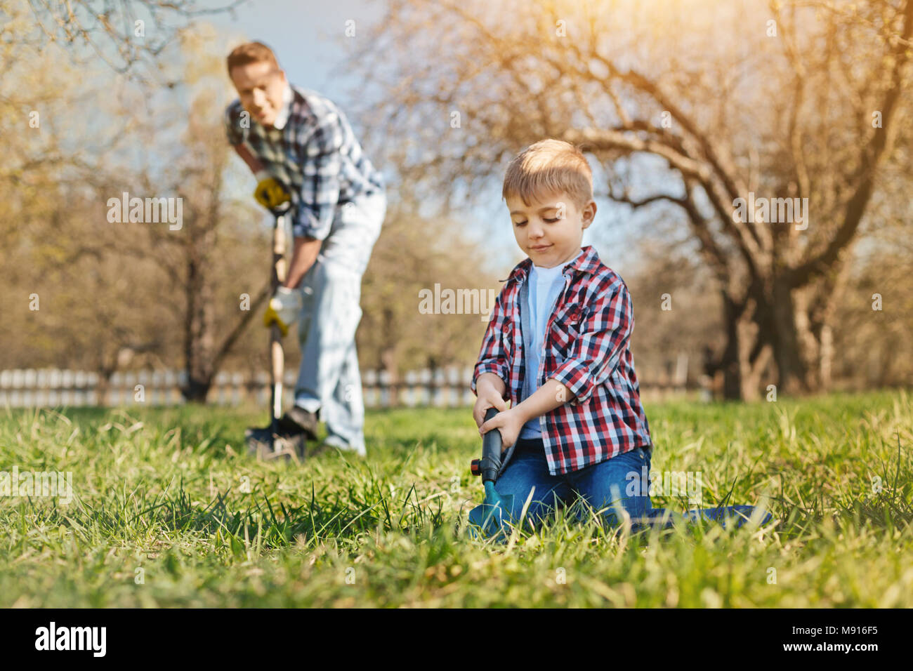 Nice little boy digging the ground Stock Photo - Alamy