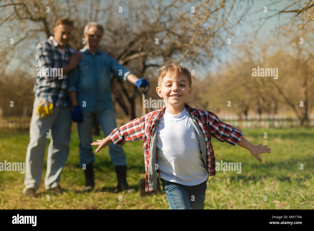 Positive smiling little boy running in the background Stock Photo - Alamy