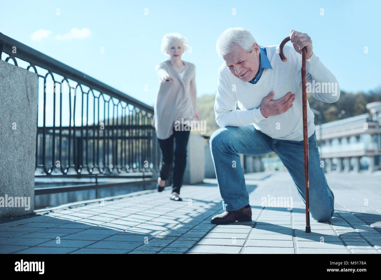 Elderly husband suffering from heart attack Stock Photo - Alamy