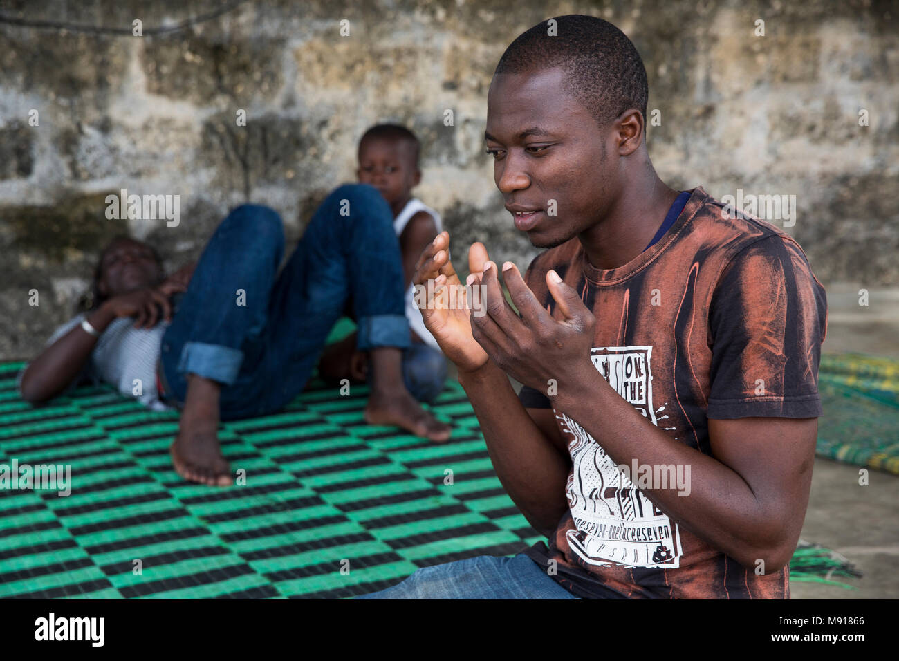 Muslim praying on a street in Cotonou, Benin Stock Photo - Alamy