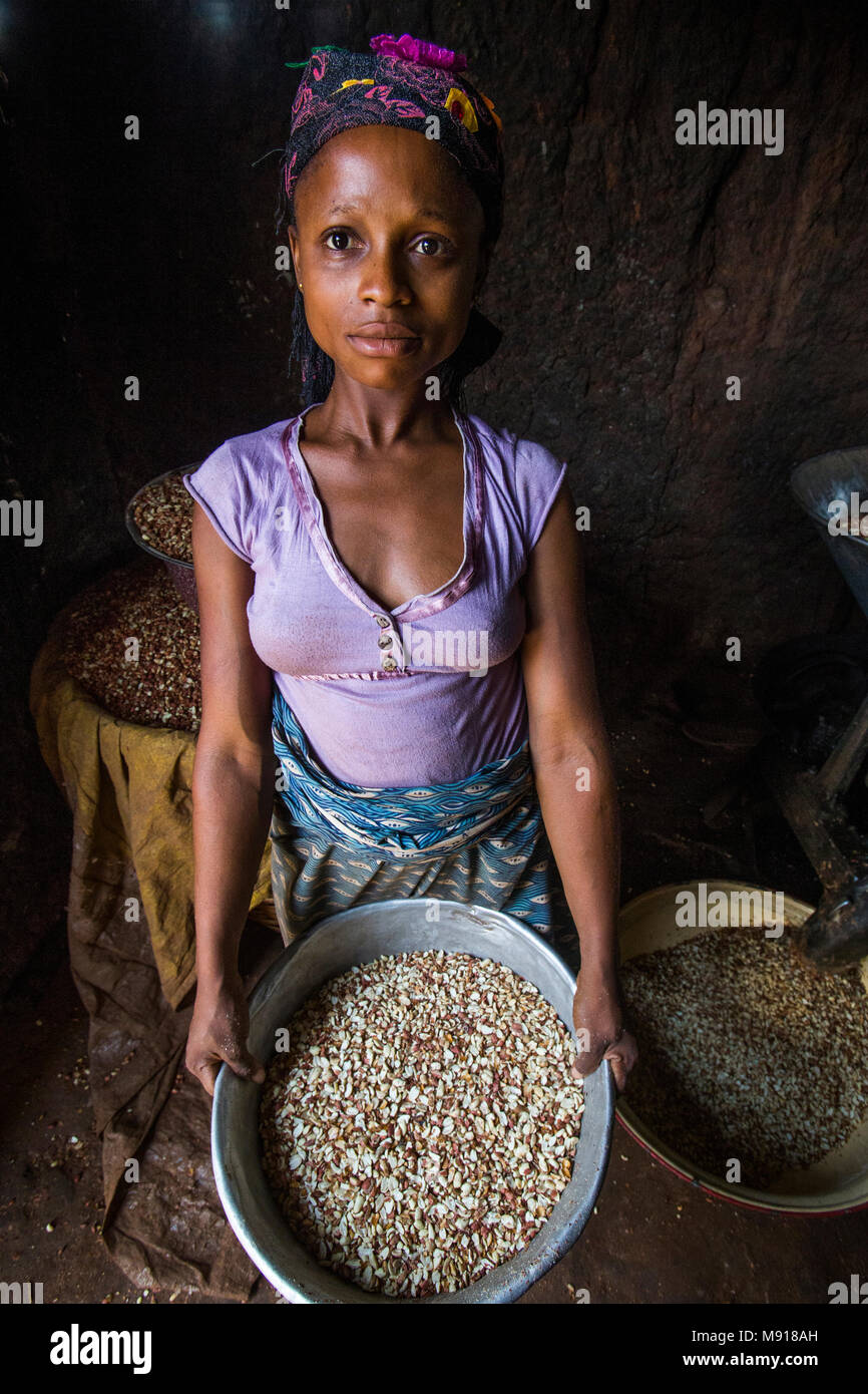 Woman carrying peanuts for groundnut paste in a Zou province village ...