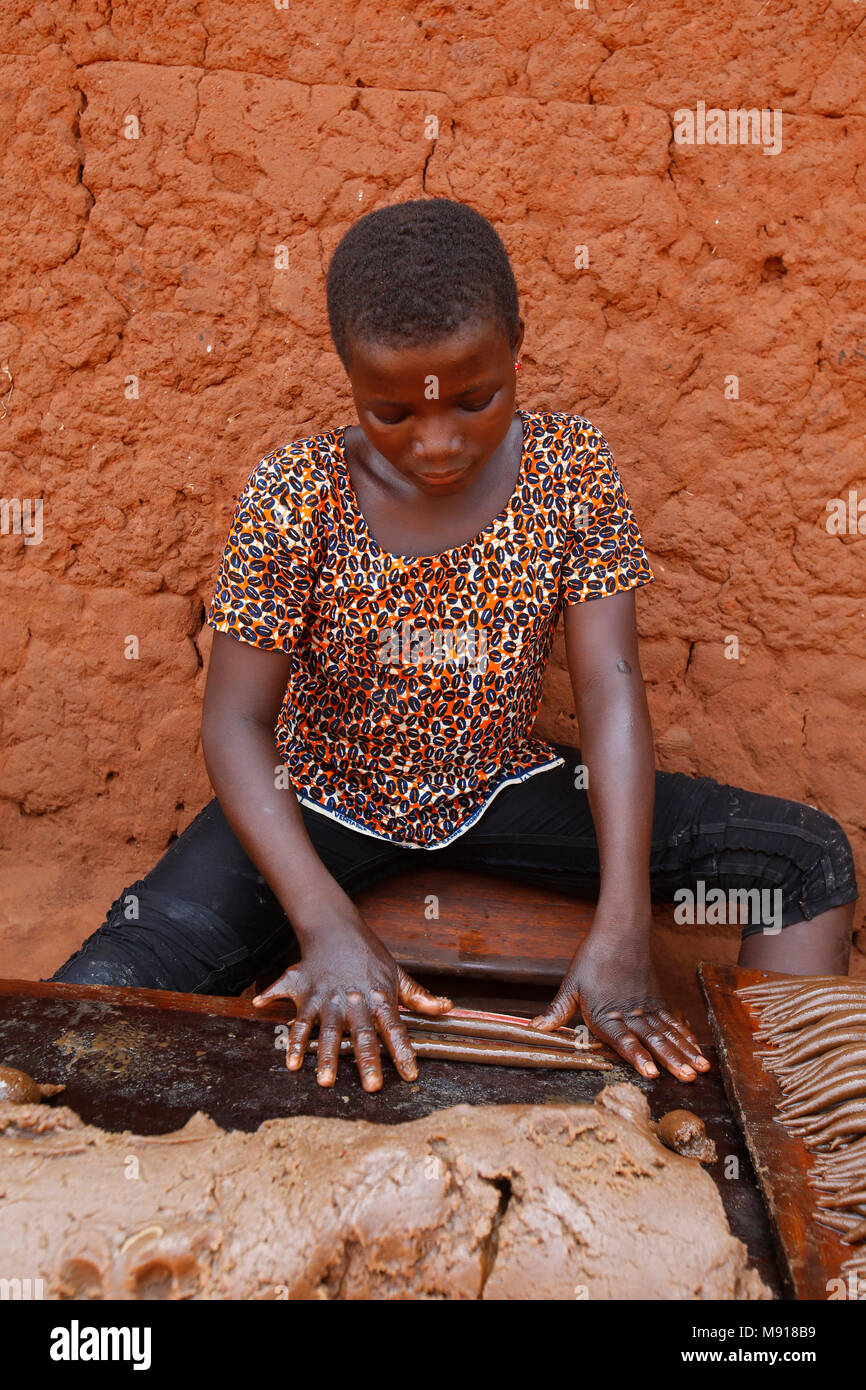 Teenager making groundnut sticks in a Zou province village, Benin Stock ...