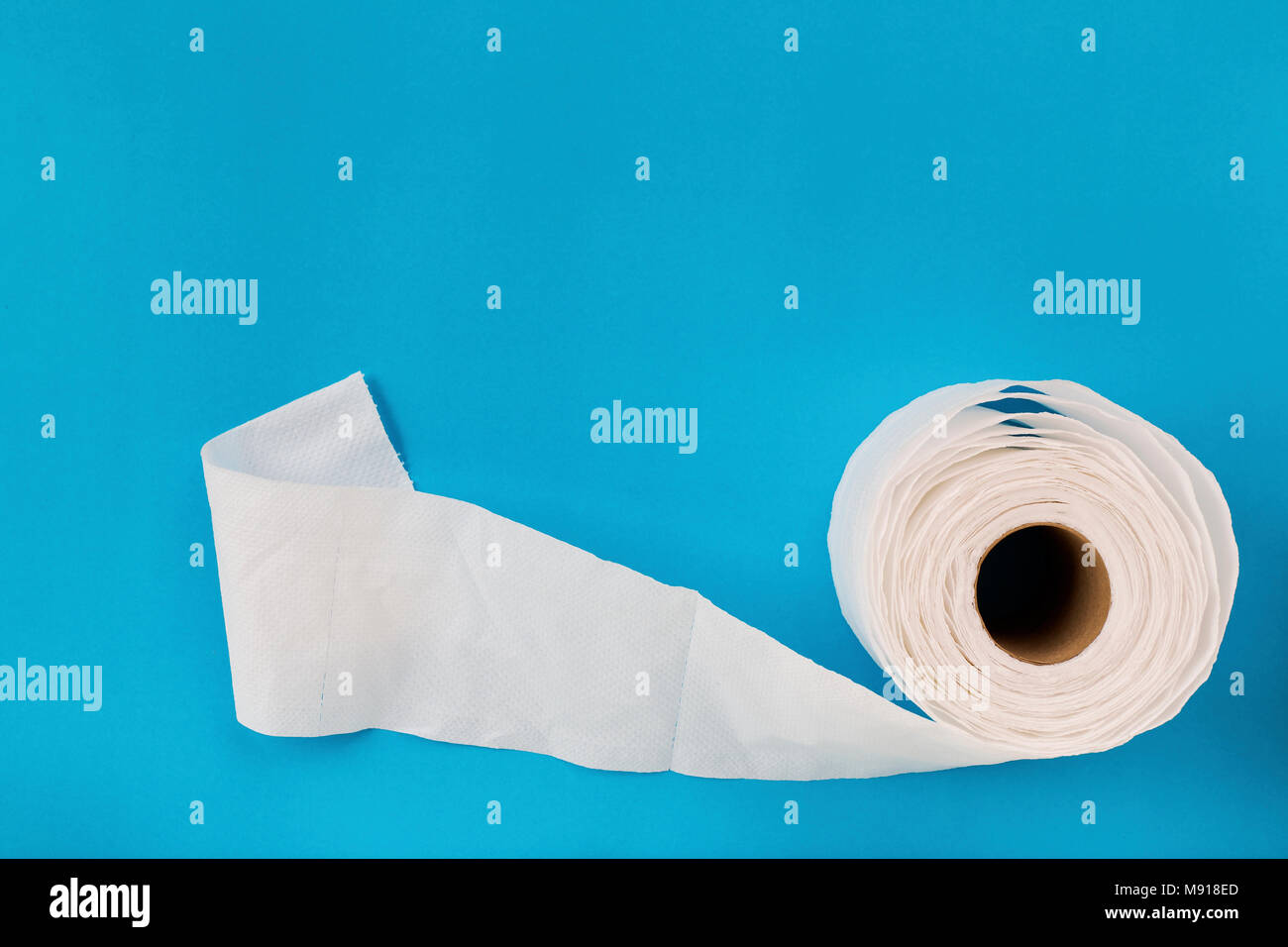 Tissue paper roll on the blue background Stock Photo - Alamy