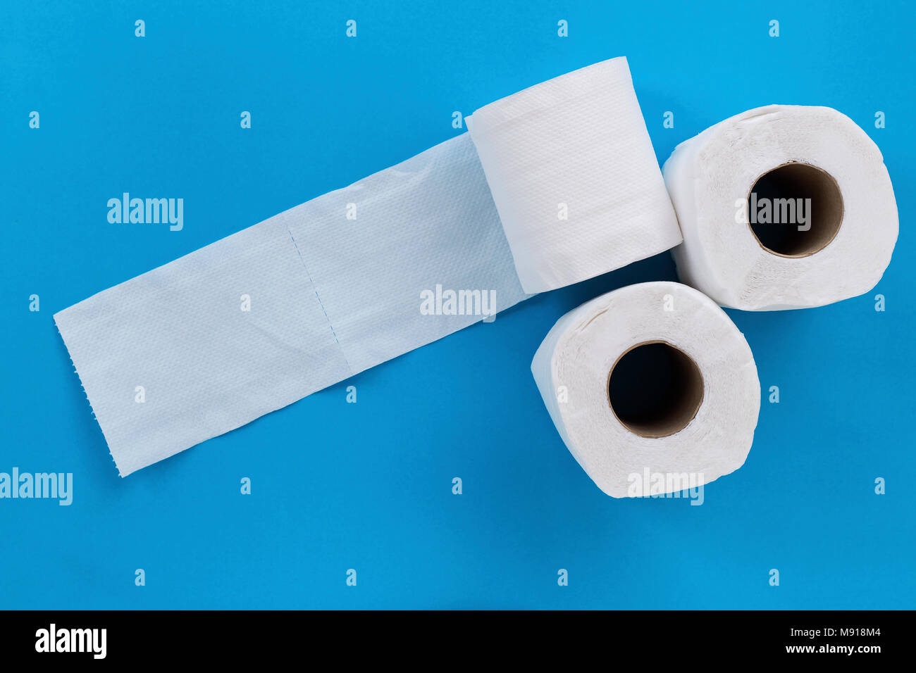 Tissue paper roll on the blue background Stock Photo - Alamy