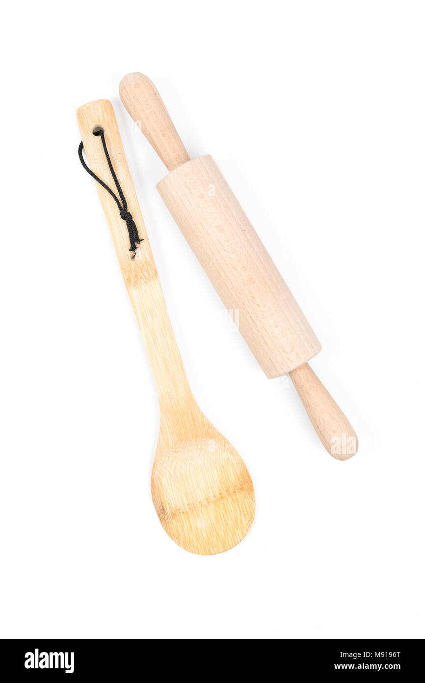 Big wooden stirring spoon and small rolling pin isolated on white ...
