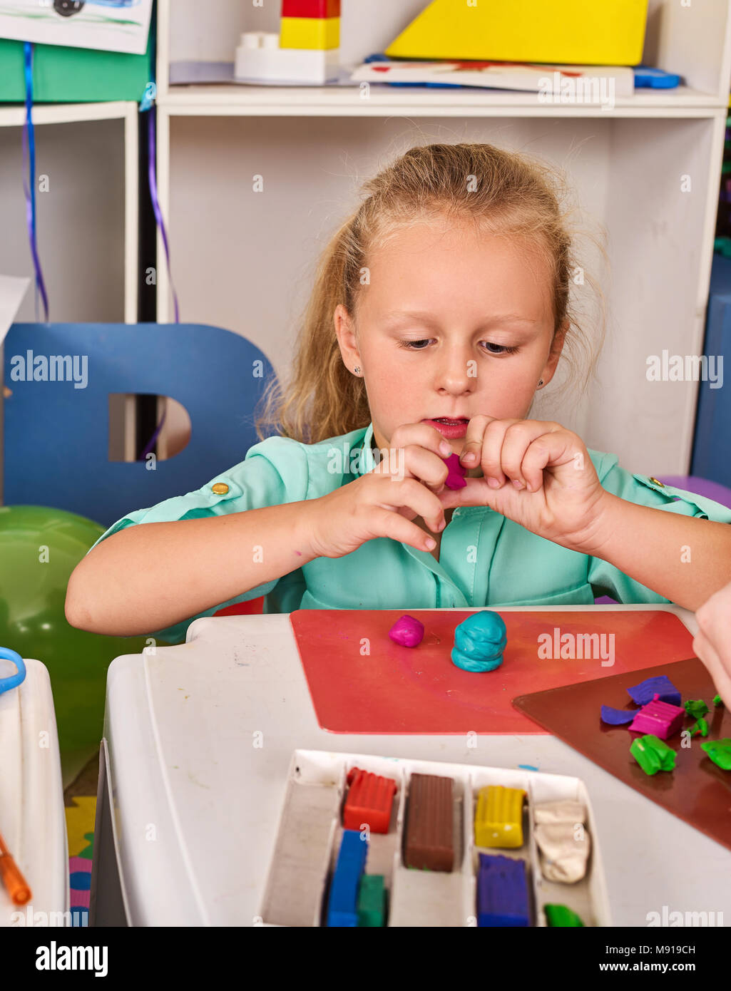 Plasticine modeling clay. Child dough play in school Stock Photo - Alamy