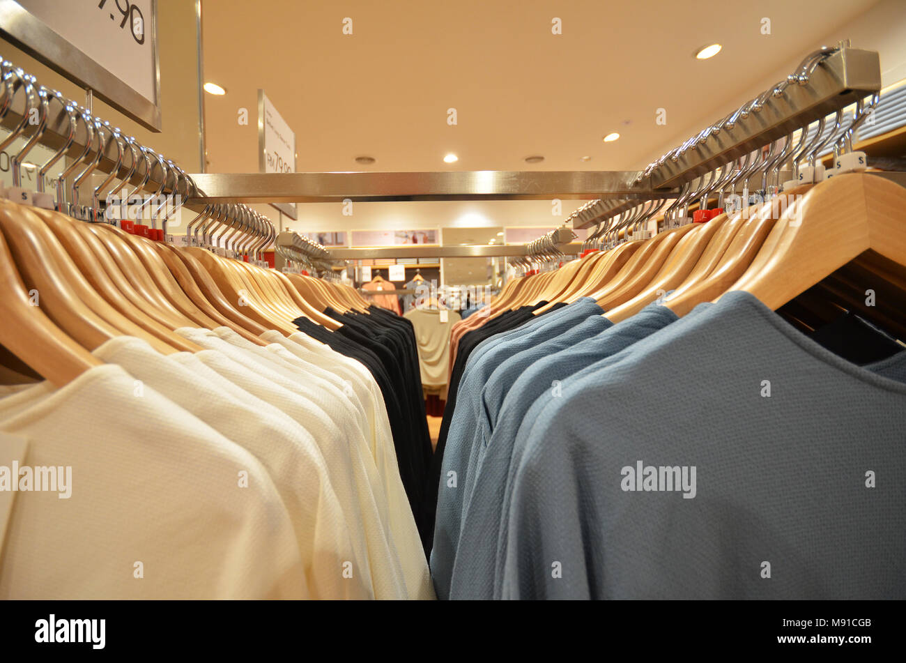 Designer clothes hanger in a row in a shop Stock Photo - Alamy
