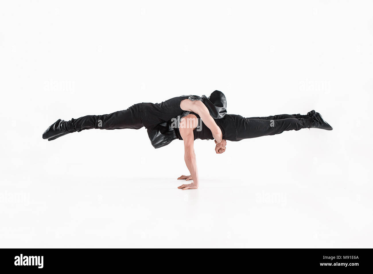 The group of gymnastic acrobatic caucasian men on balance pose Stock ...