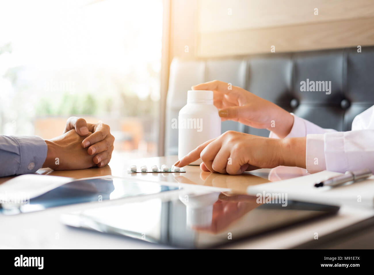 doctor hand holding tablet of drug and explain to patient in hospital ...