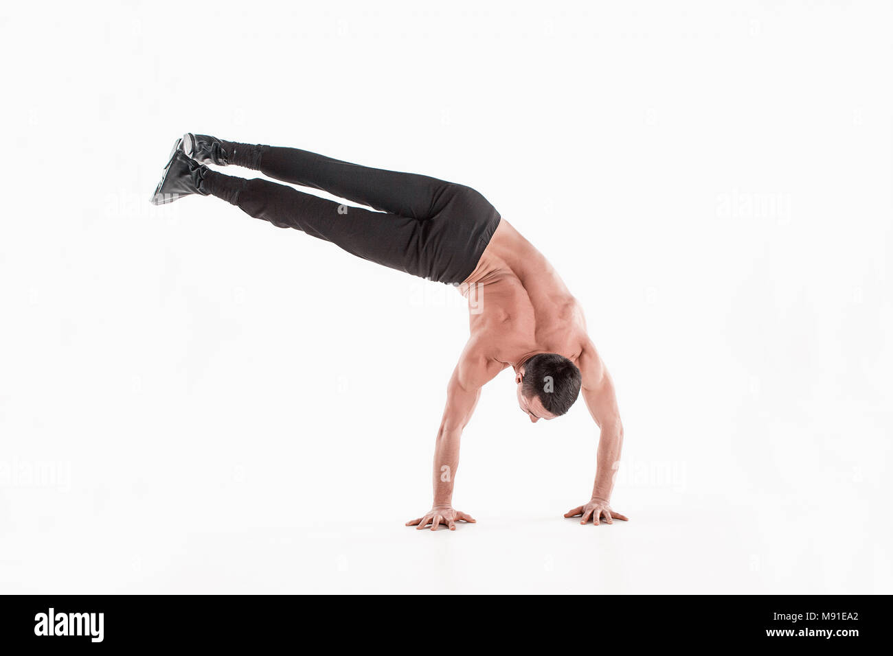 The group of gymnastic acrobatic caucasian men on balance pose Stock ...