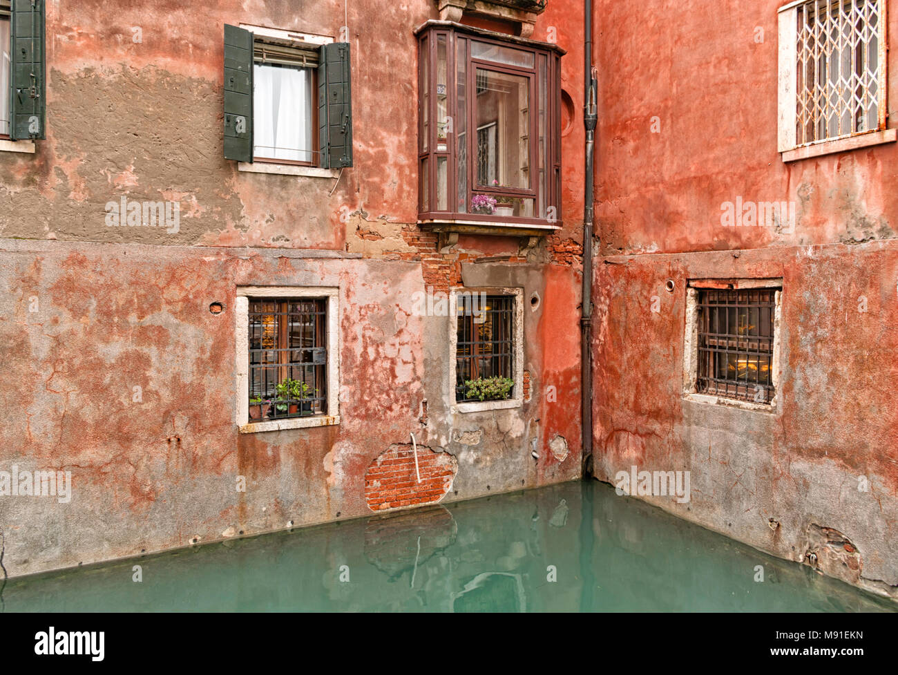 A hidden corner of old traditional Venetian buildings with red bricks ...