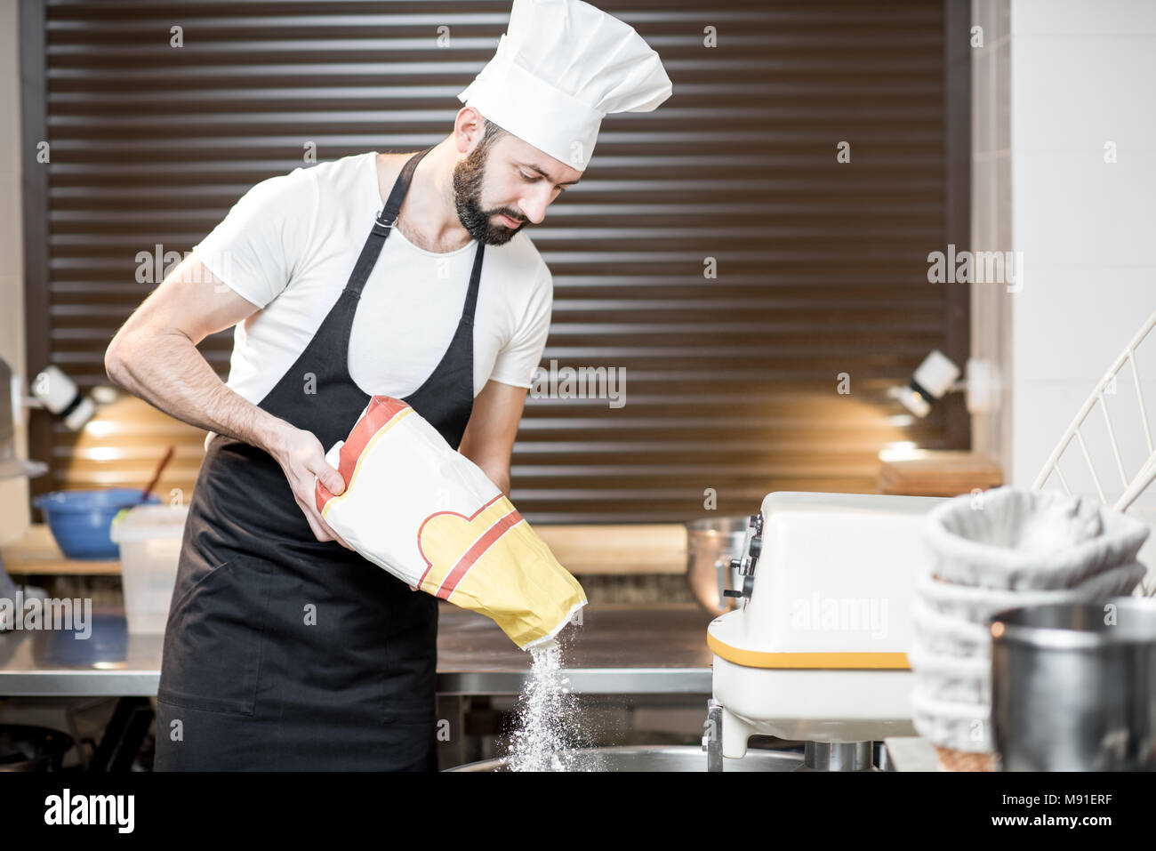 Baker pouring flour machine hi-res stock photography and images - Alamy