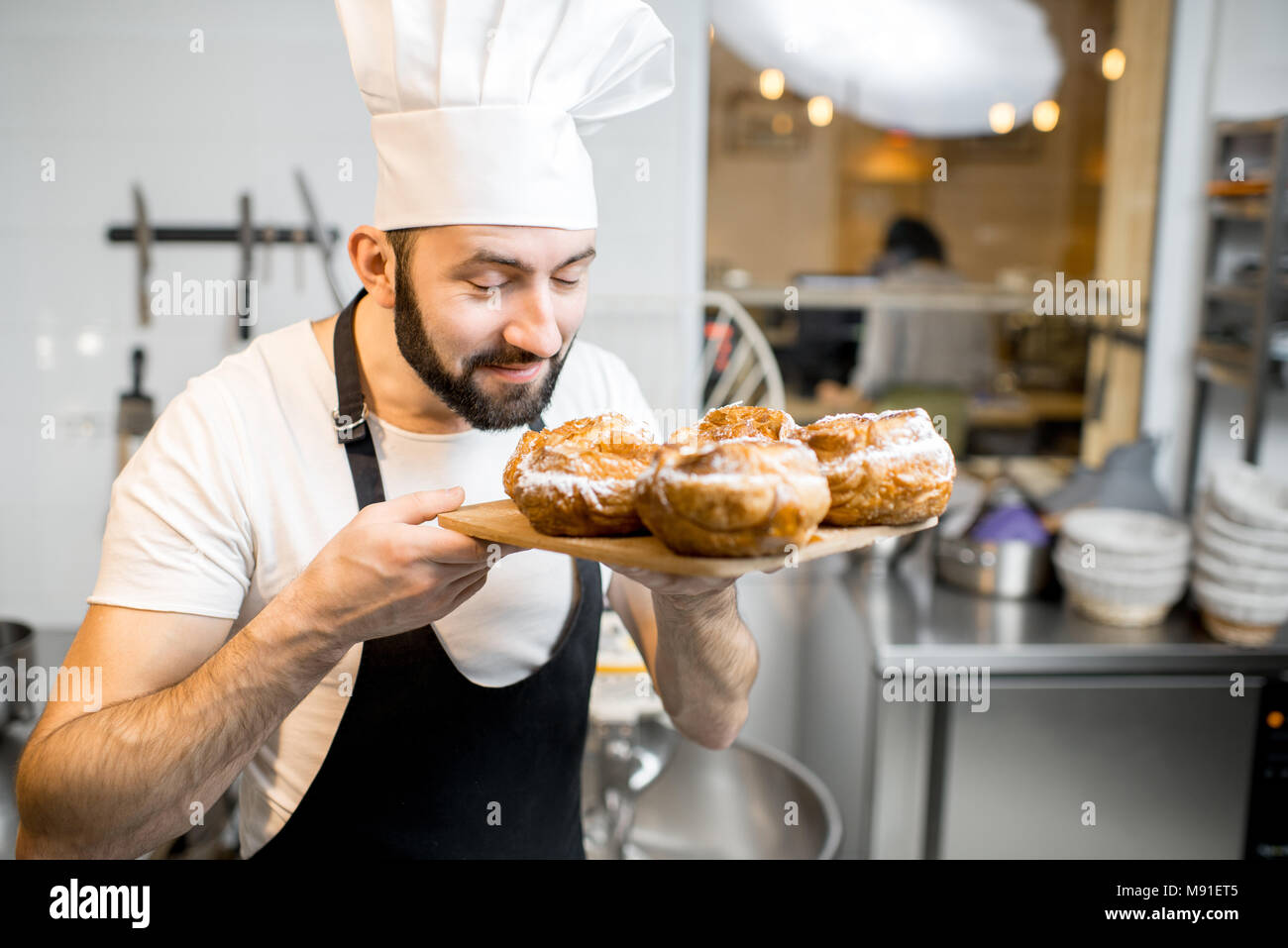 Confectioner with sweet pastry indoors Stock Photo - Alamy